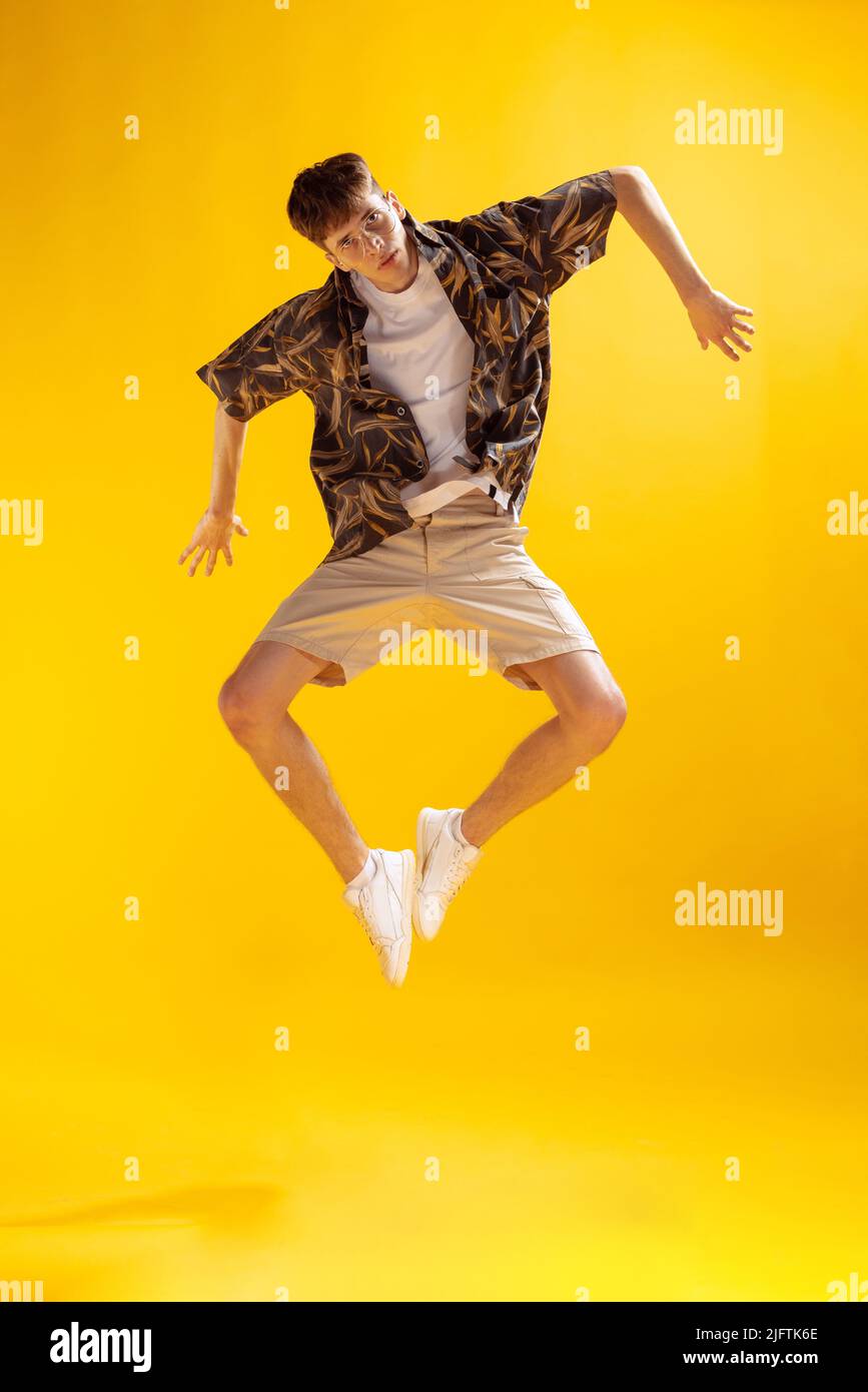 Full-length man's portrait isolated on bright yellow studio backgroud ...