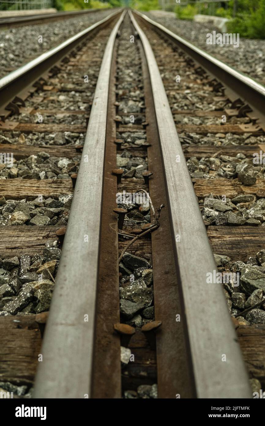 A train track used by commuter and freight trains in a suburban town ...