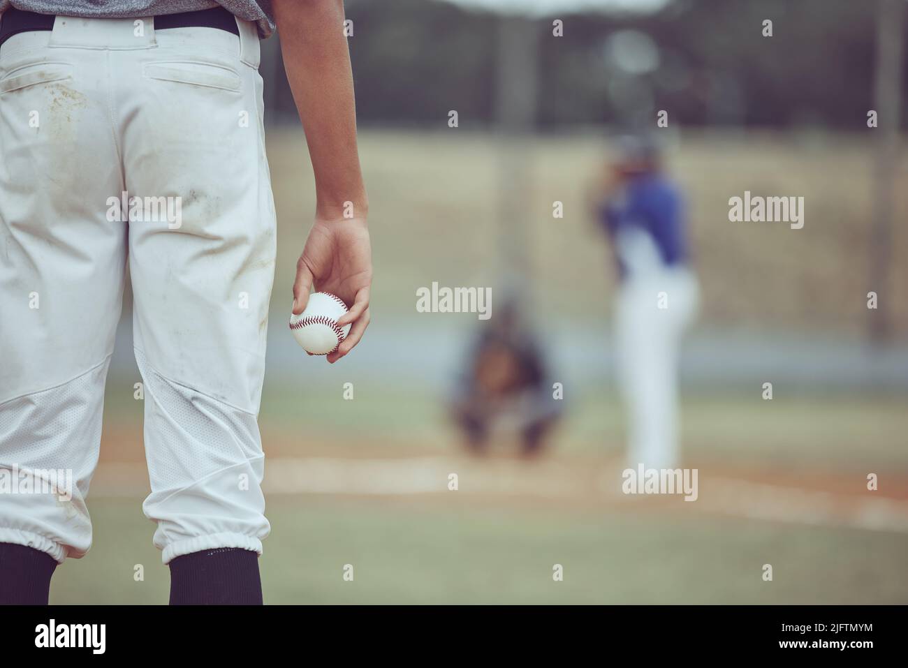 Baseball player holding ball during a game on the field. Man ...