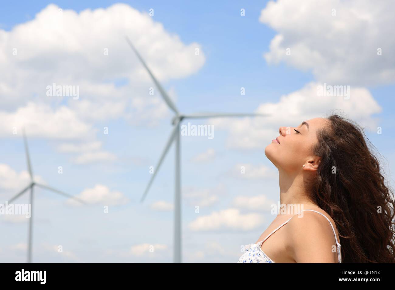Profile of a relaxed woman breathing fresh air in a wind farm Stock ...