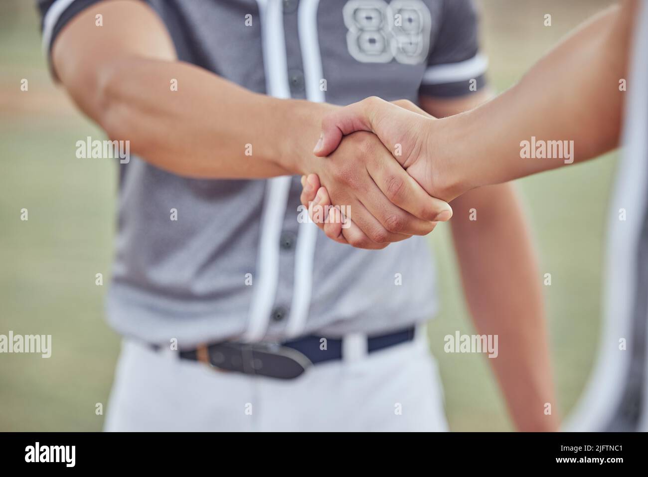 Closeup of two sportsmen shaking hands before a game. Hands pf baseball ...