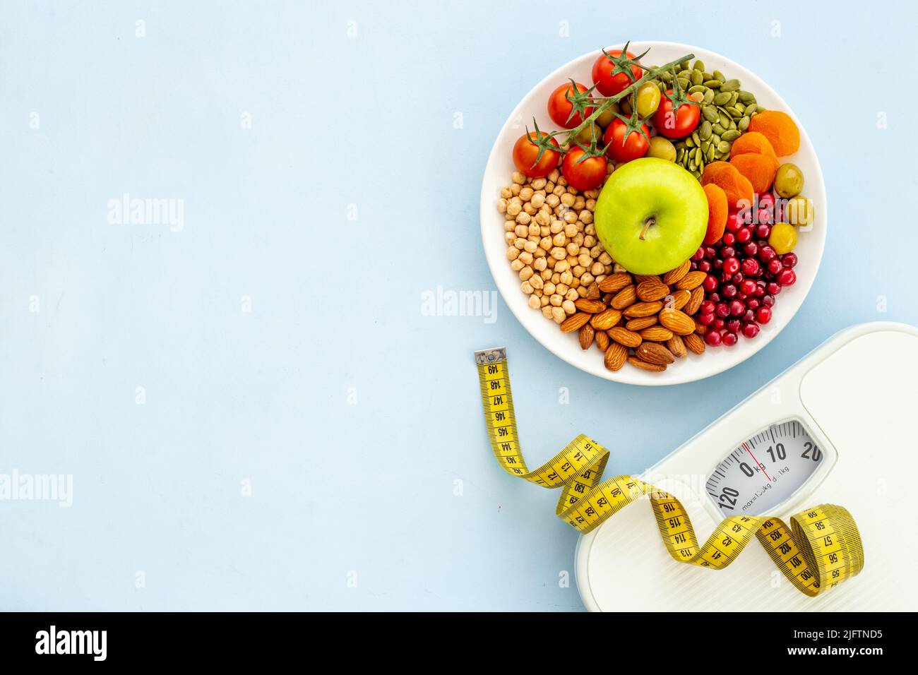 Heart shaped dish of fruits and healthy food with weight scale Stock ...