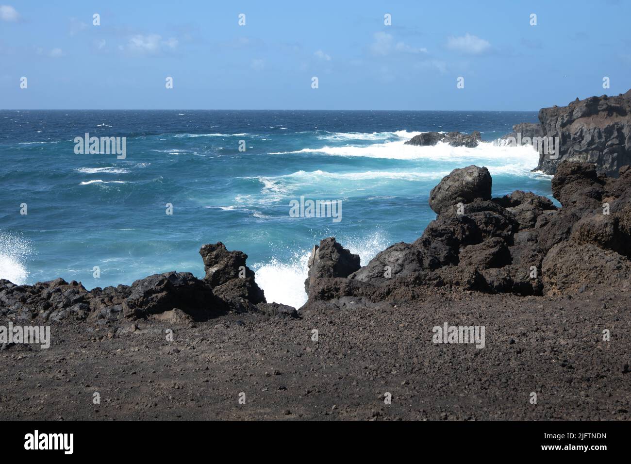Rocks made of dark brown to black lava, creating the Atlantic ocean ...