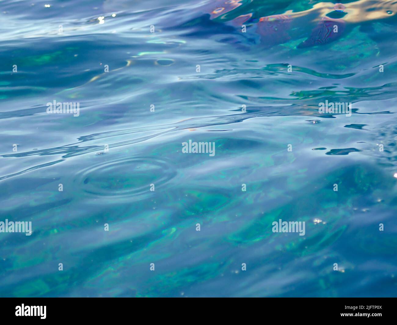 A low angle view of the Pacific ocean blue water in Maui Hawaii for a ...