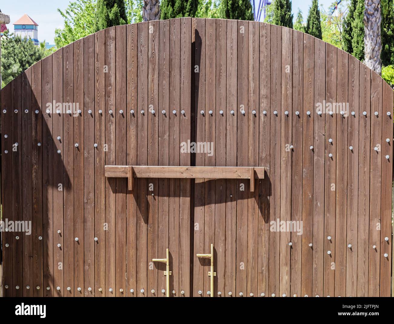 Wooden gates in the folk style closed with bolts. Fairytale gate in ...