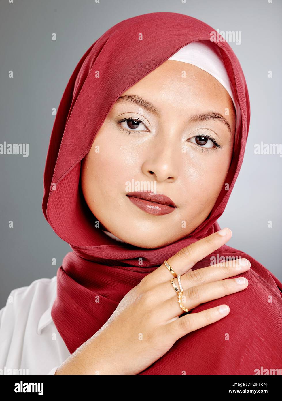 Portrait of stylish muslim woman with makeup and gold rings isolated ...