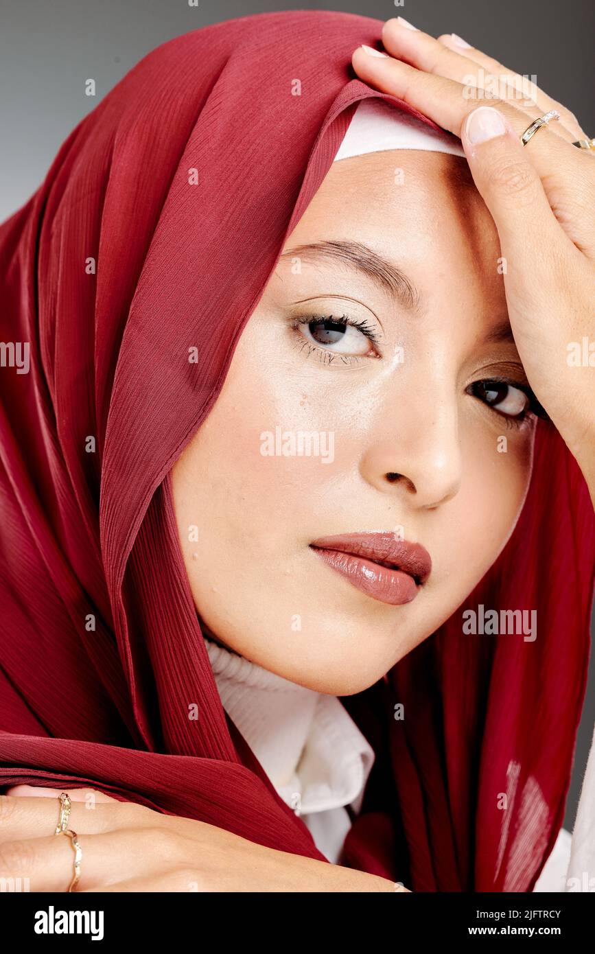 Portrait of an elegant muslim woman in a hijab posing in a studio ...