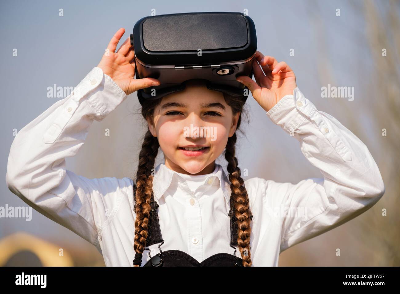 Little girl with virtual reality glasses. Future technology concept ...