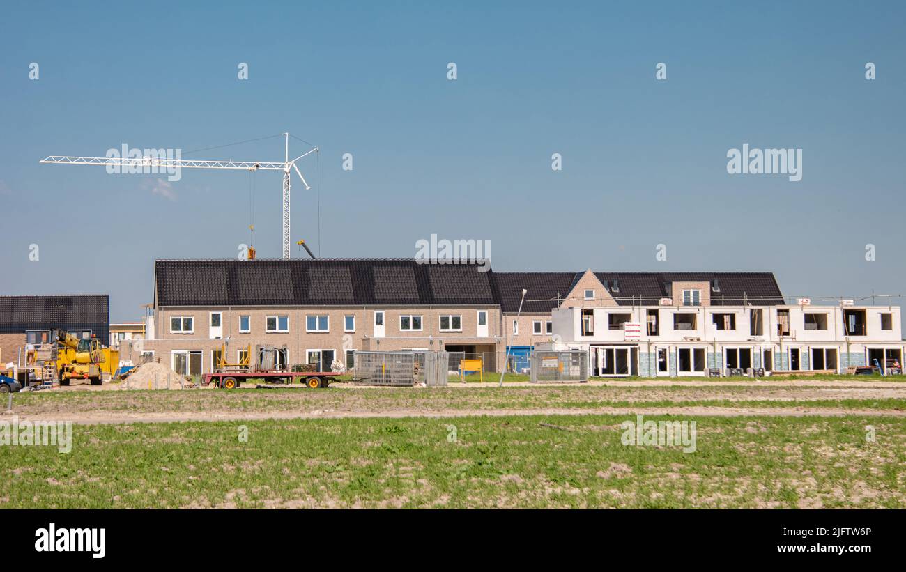 Newly build houses with solar panels attached on the roof against a ...