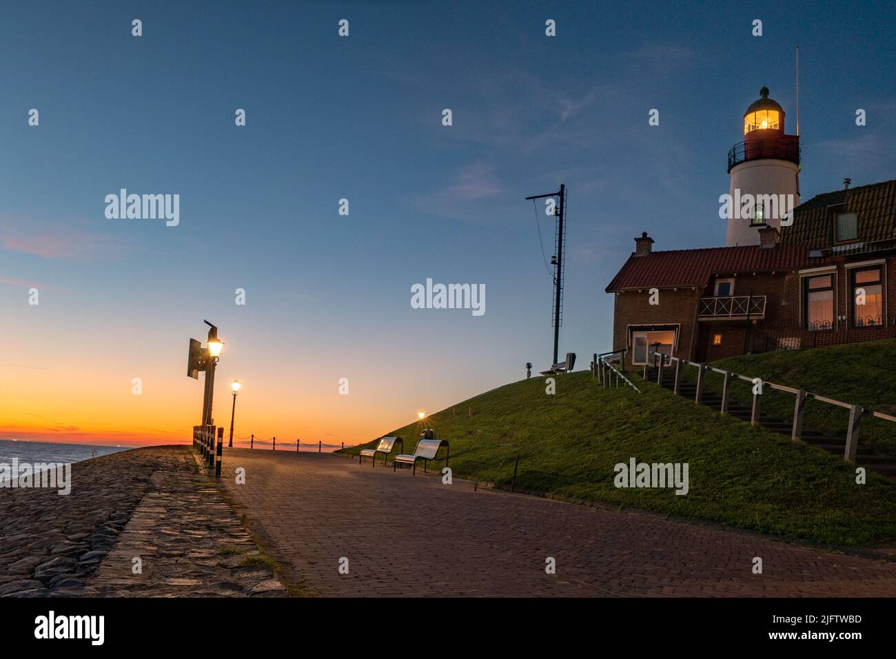 Urk Flevoland Netherlands sunset at the lighthouse and harbor of Urk ...