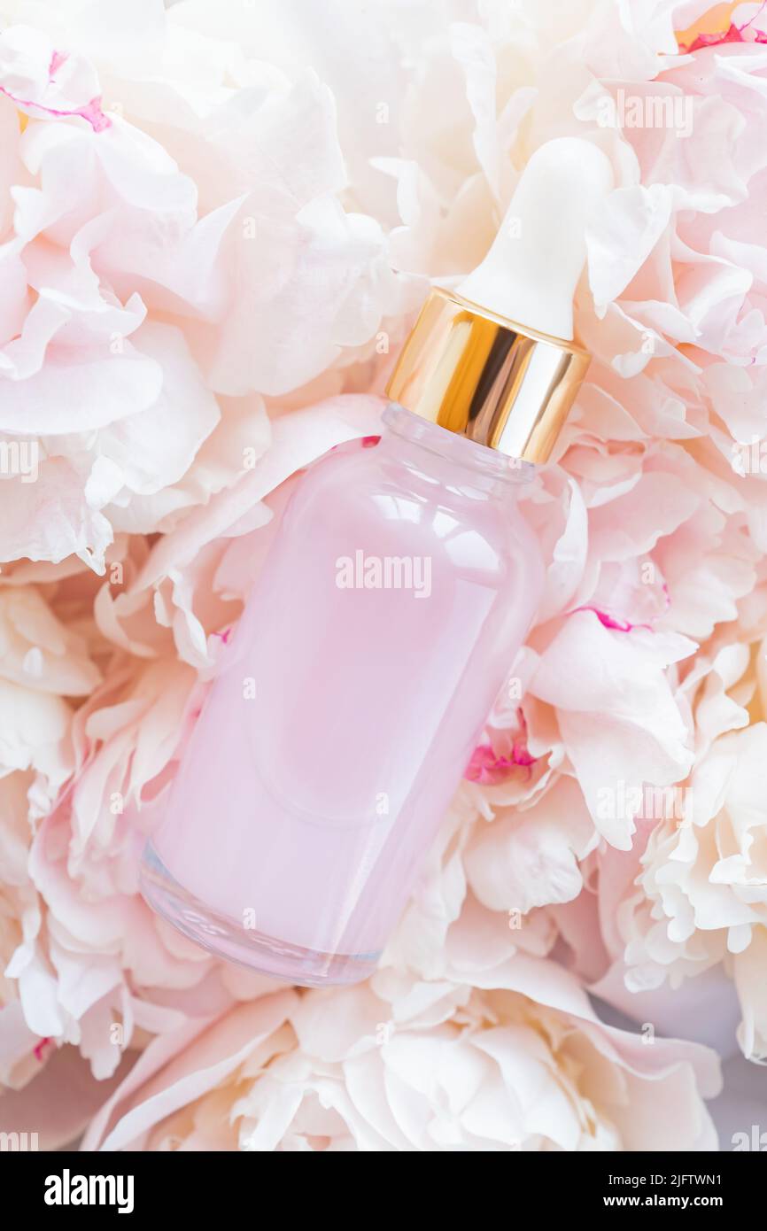 Glass dropper bottle peony flower. petals background. Hyaluronic acid ...