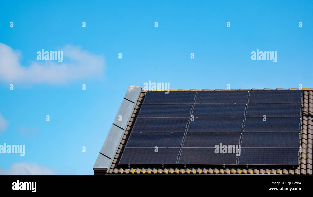 Newly build houses with solar panels attached on the roof against a ...