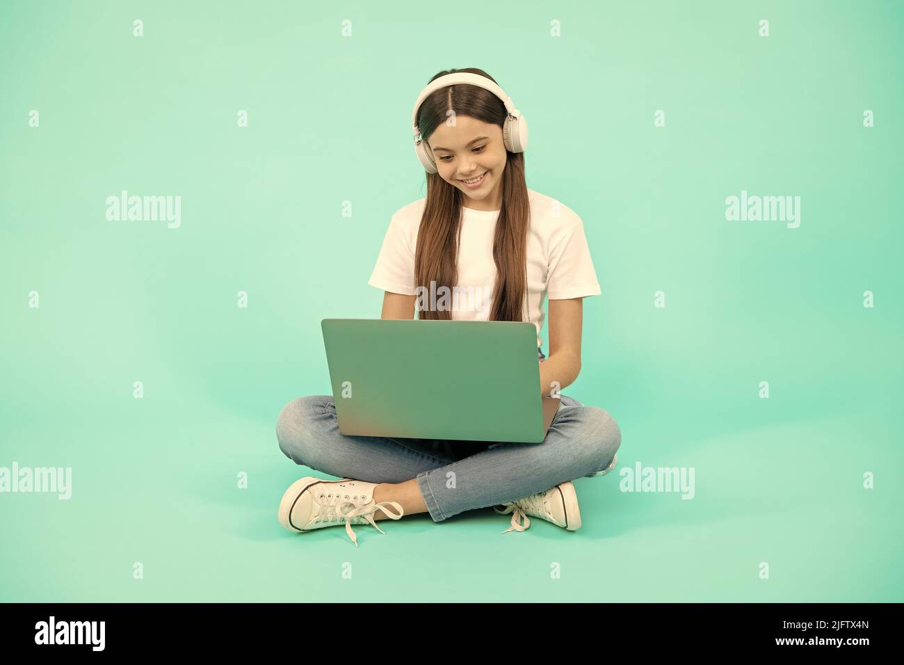 happy teen girl use computer for video call or listen webinar in ...