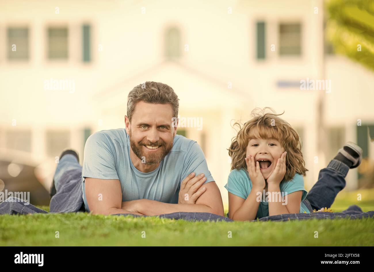 childhood and parenthood. parent relax with little child boy on grass ...