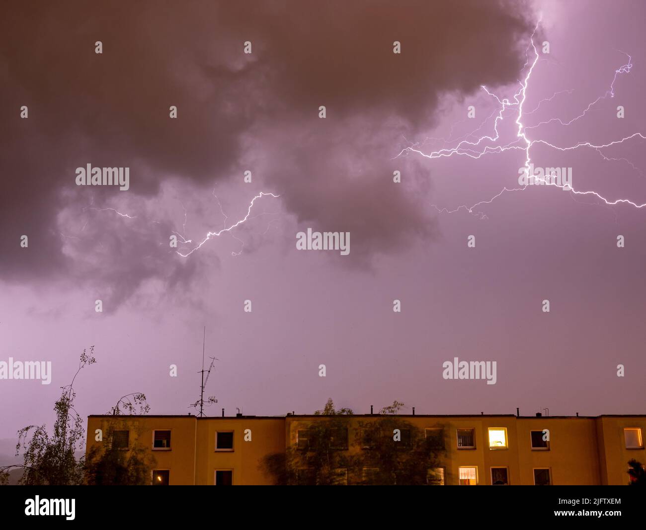 Thunderstorm with branching lightning over a residential house - long ...