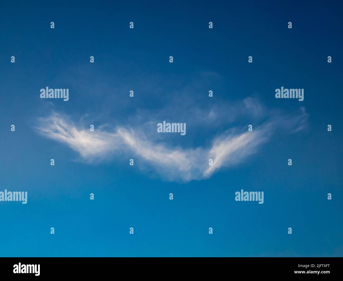 Clouds in the shape of beautiful angel wings. The sky changes from dark ...