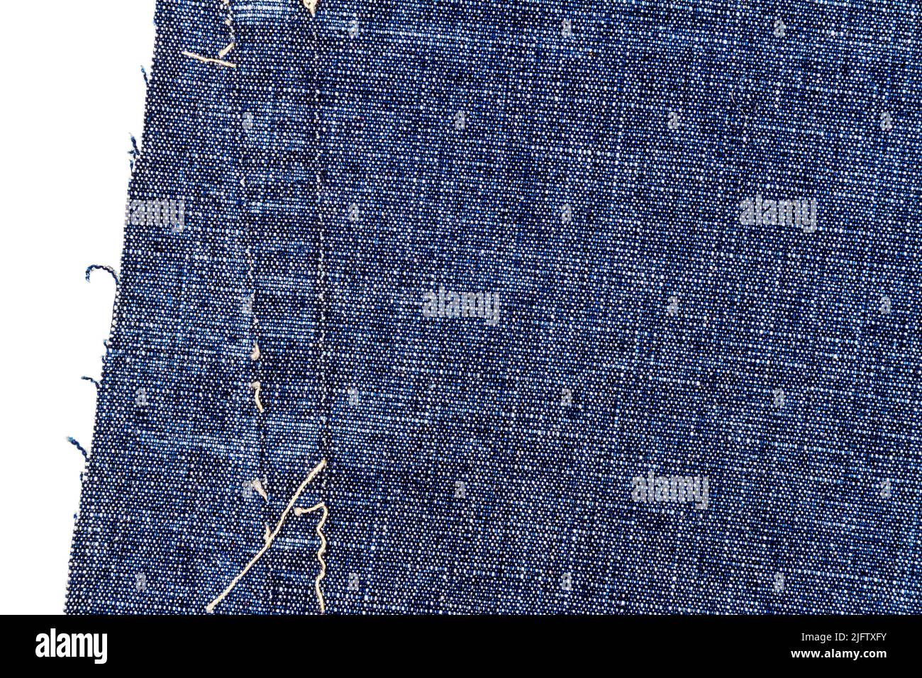 Piece of blue jeans fabric with a ripped of back pocket isolated on ...