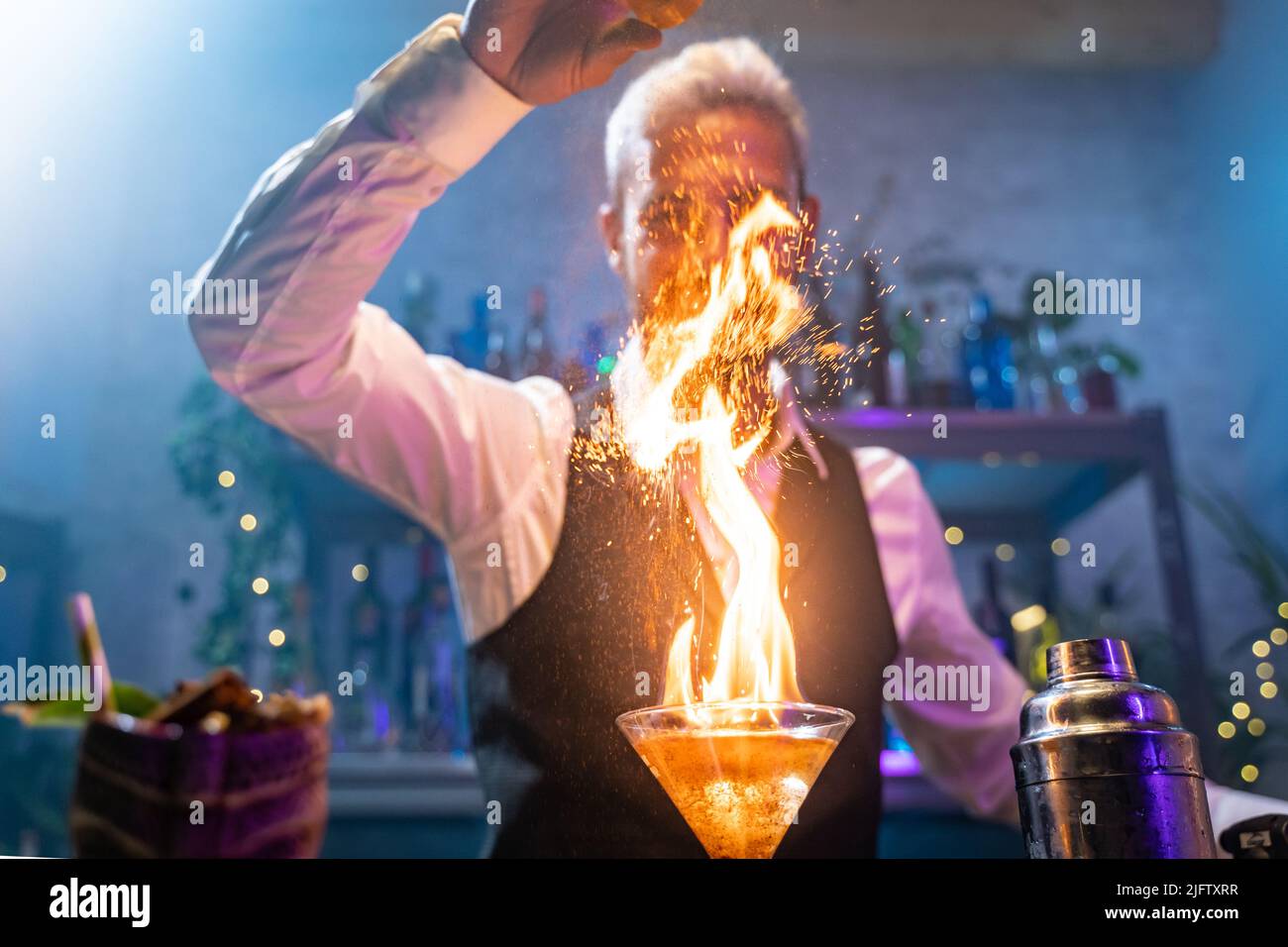 Bartender making a cocktail with fire flame unique experience Stock ...