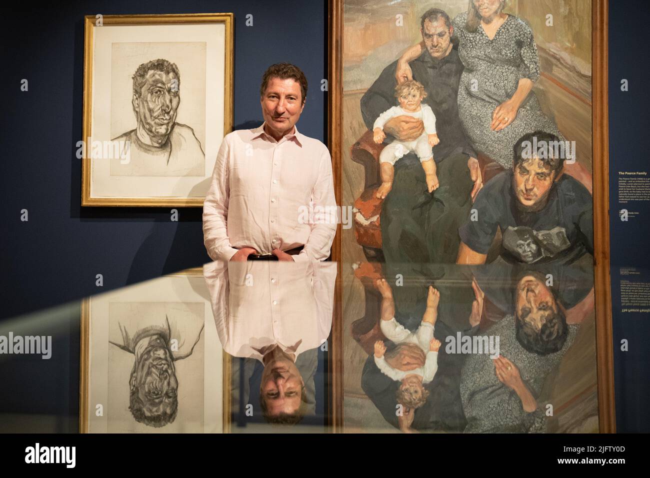 Alex Boyt, son of Lucien Freud stands in front of a portrait of himself ...