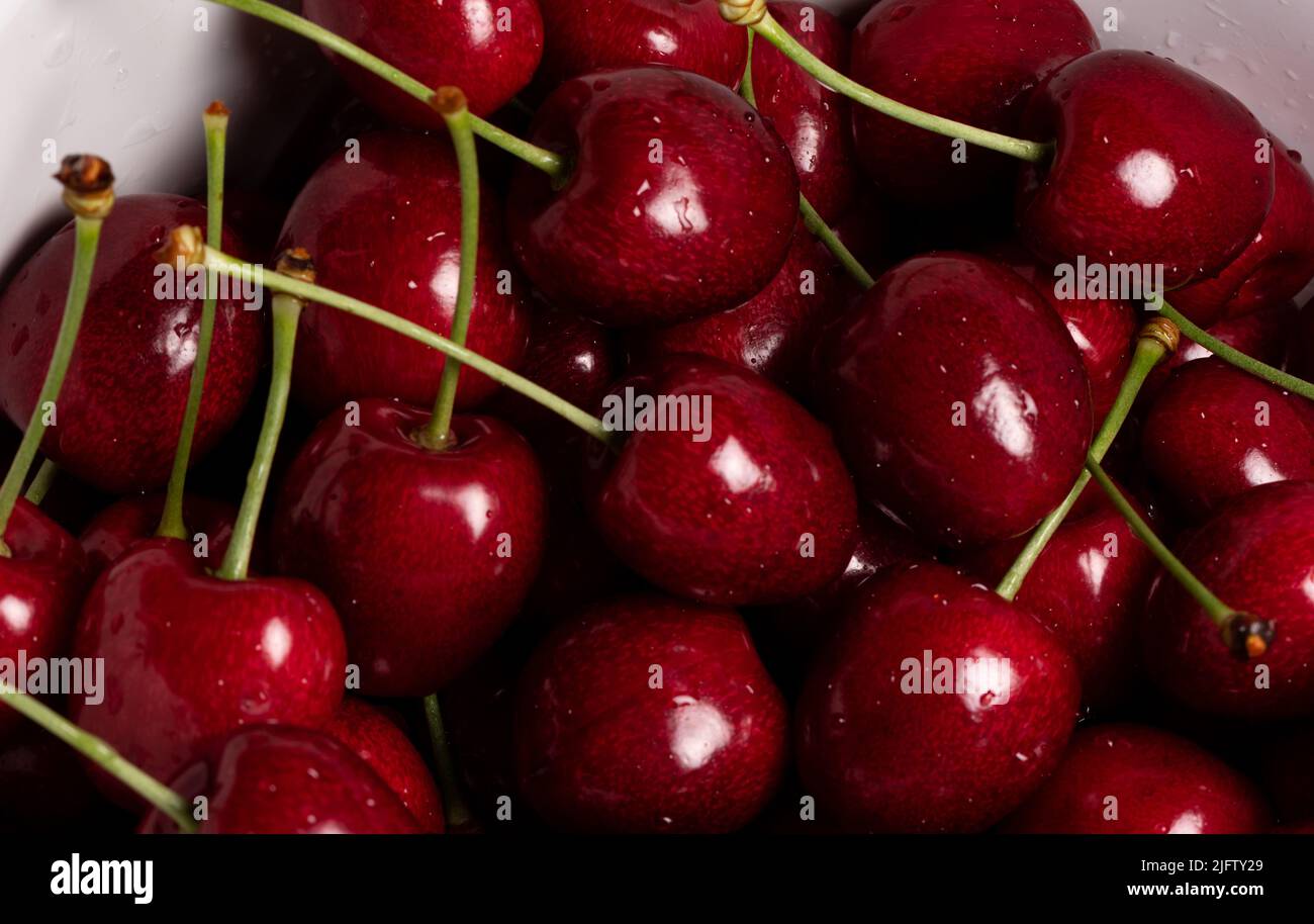 Red juicy sweet cherries. Juicy maroon fruit close-up. Cherries in ...
