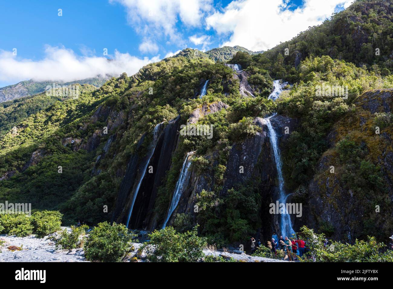 A low-angle shot of waterfalls in Fox Glacier, Westland Tai Poutini ...