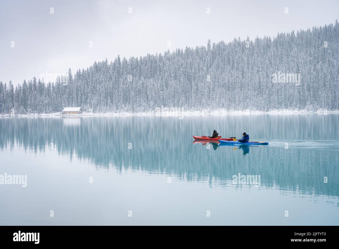 Two kayaks on azure alpine lake during early winter, Banff N. Park ...