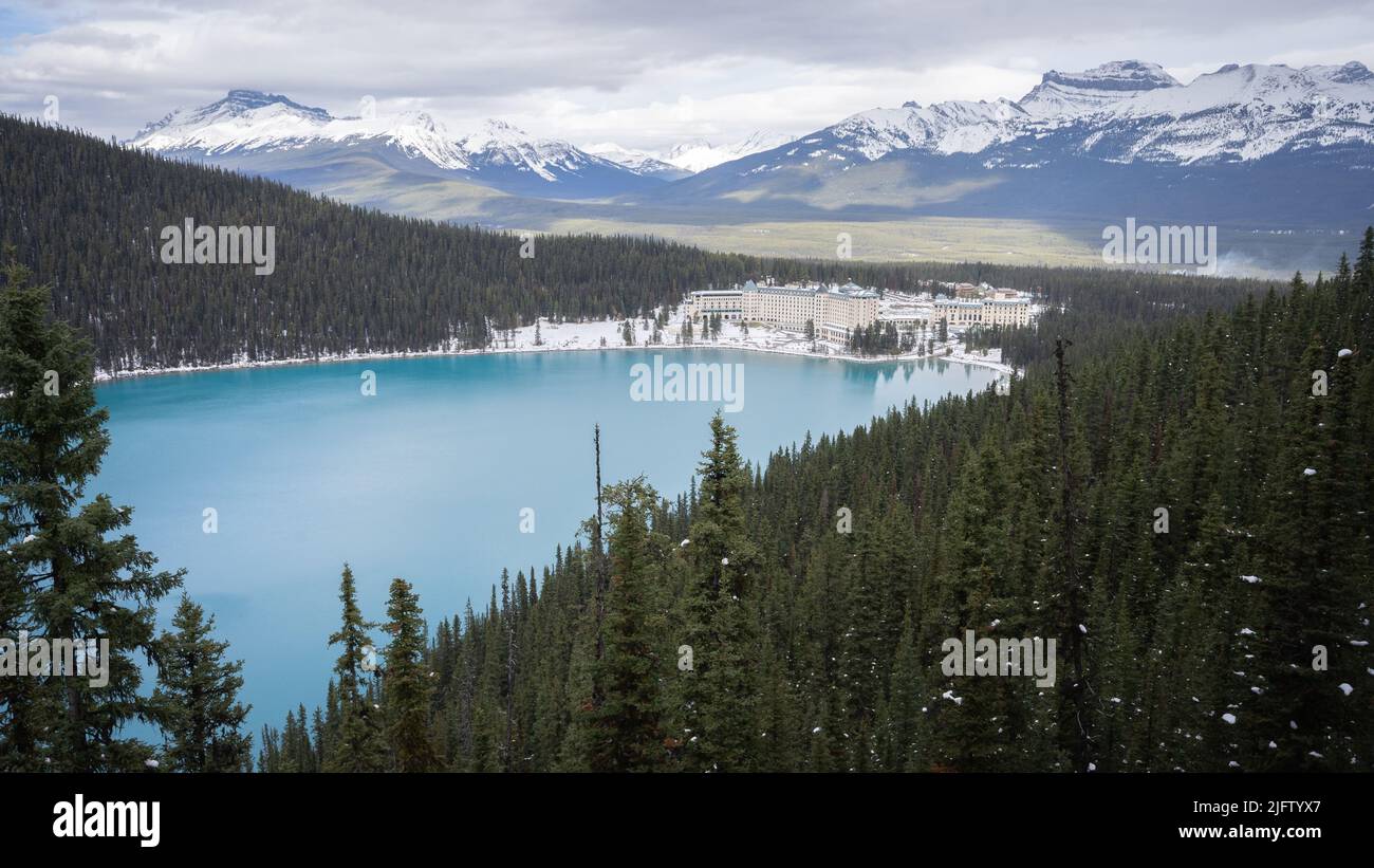 Azure alpine lake surrounded by forest and mountains with castlelike ...
