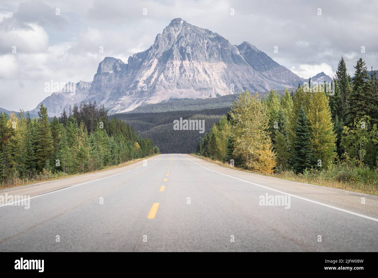 Deserted alpine highway leading to the prominent mountain in the ...
