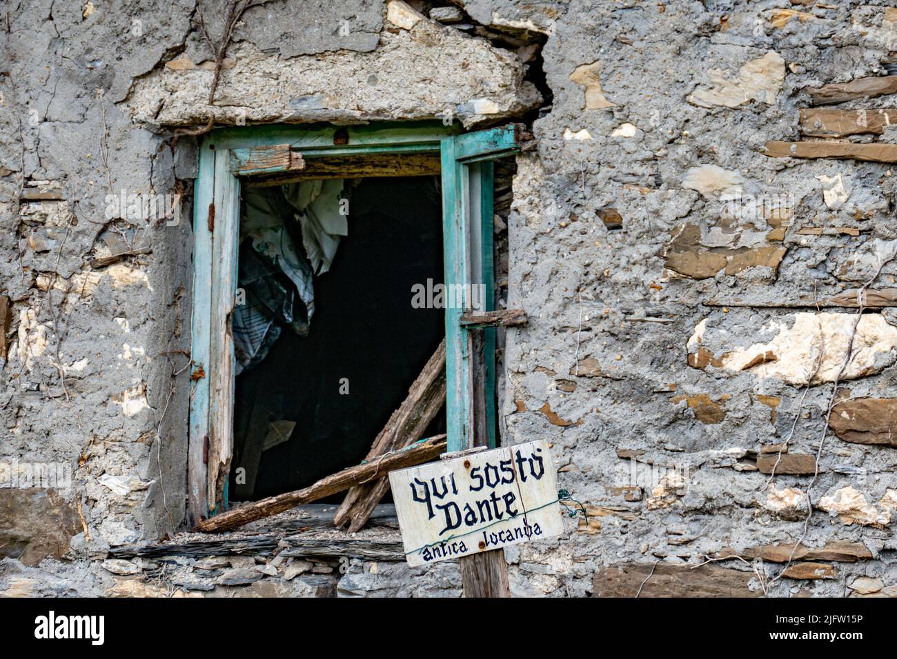 A view of an old stone house window with a sign Stock Photo - Alamy