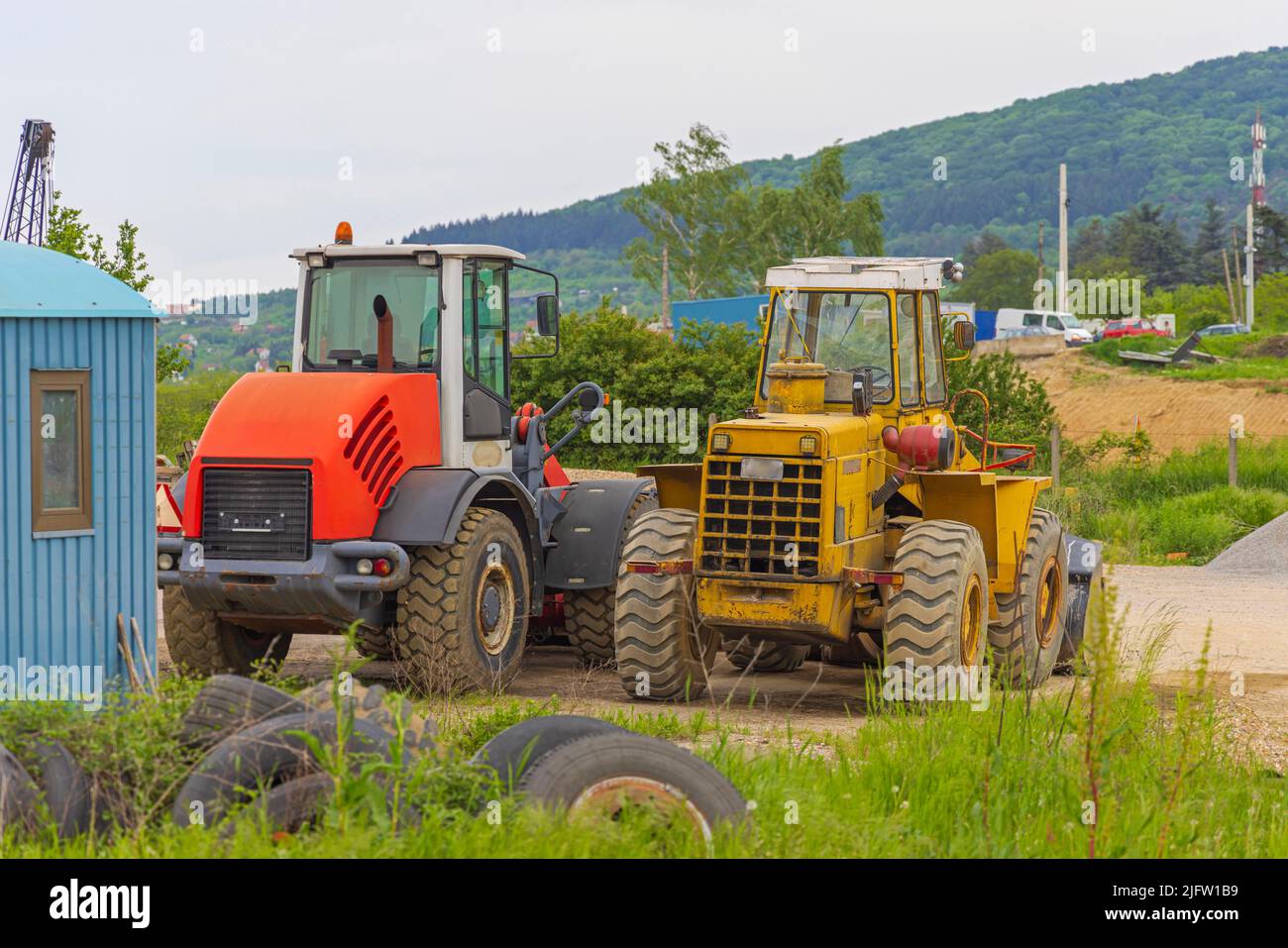 New and Old Wheel Loaders Machinery at Road Construction Site Stock ...