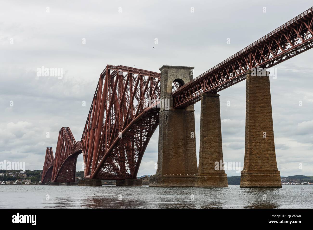 Forth Bridge from below, with Firth of Forth visible and clear sky ...