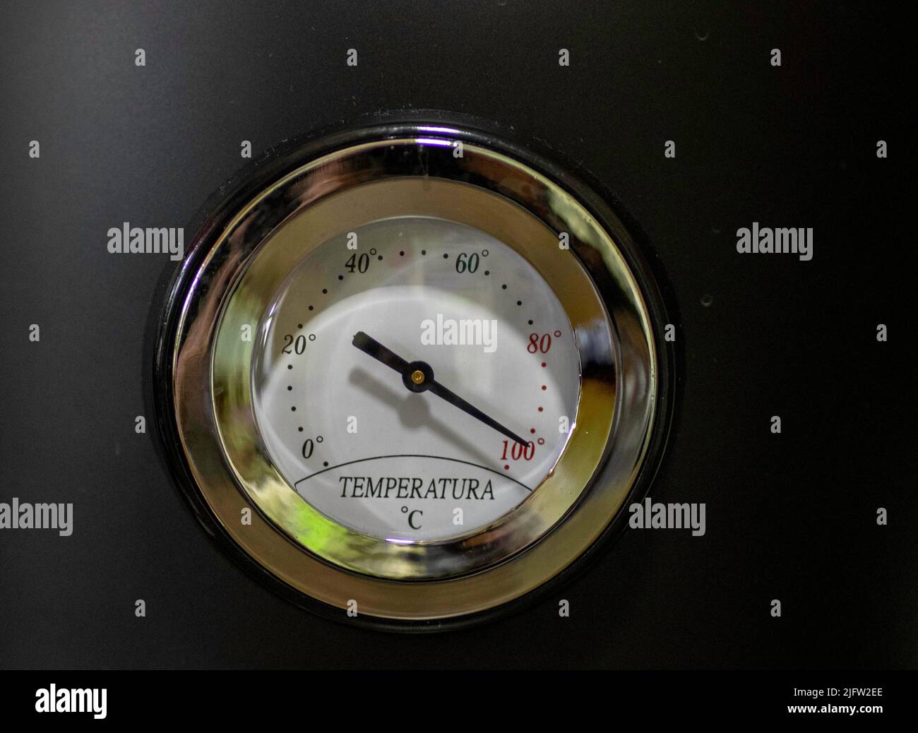 temperature sensor at 100 degrees on a black container Stock Photo - Alamy