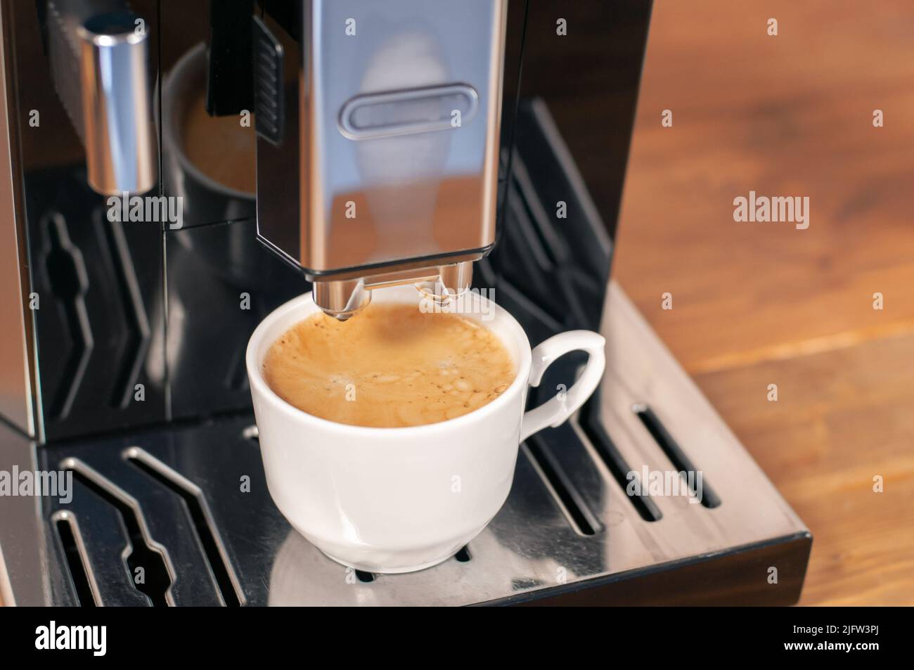 Espresso pouring from coffee machine, close up, professional coffee ...