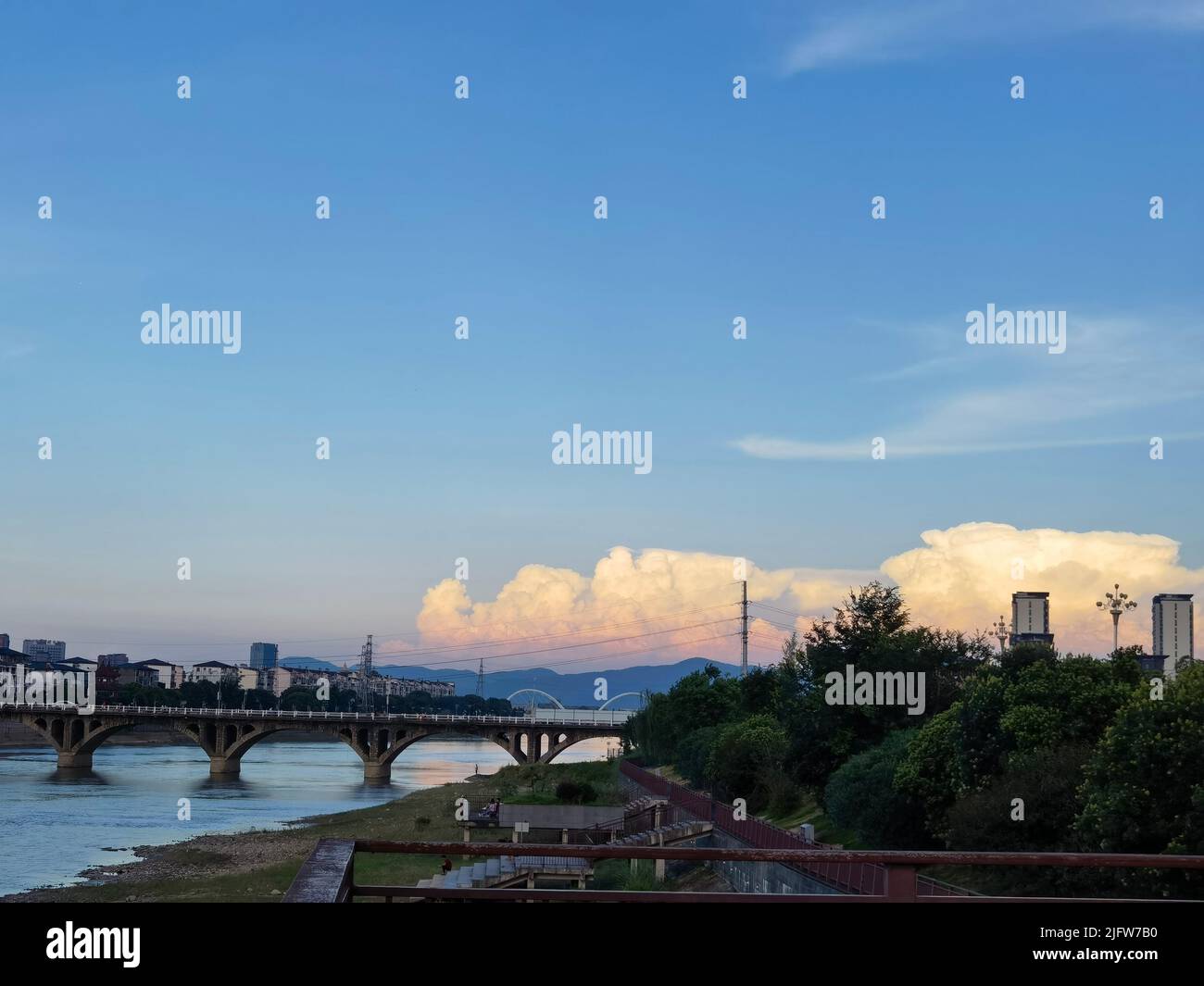 An aerial view of bridge over lake surrounded by buildings during ...