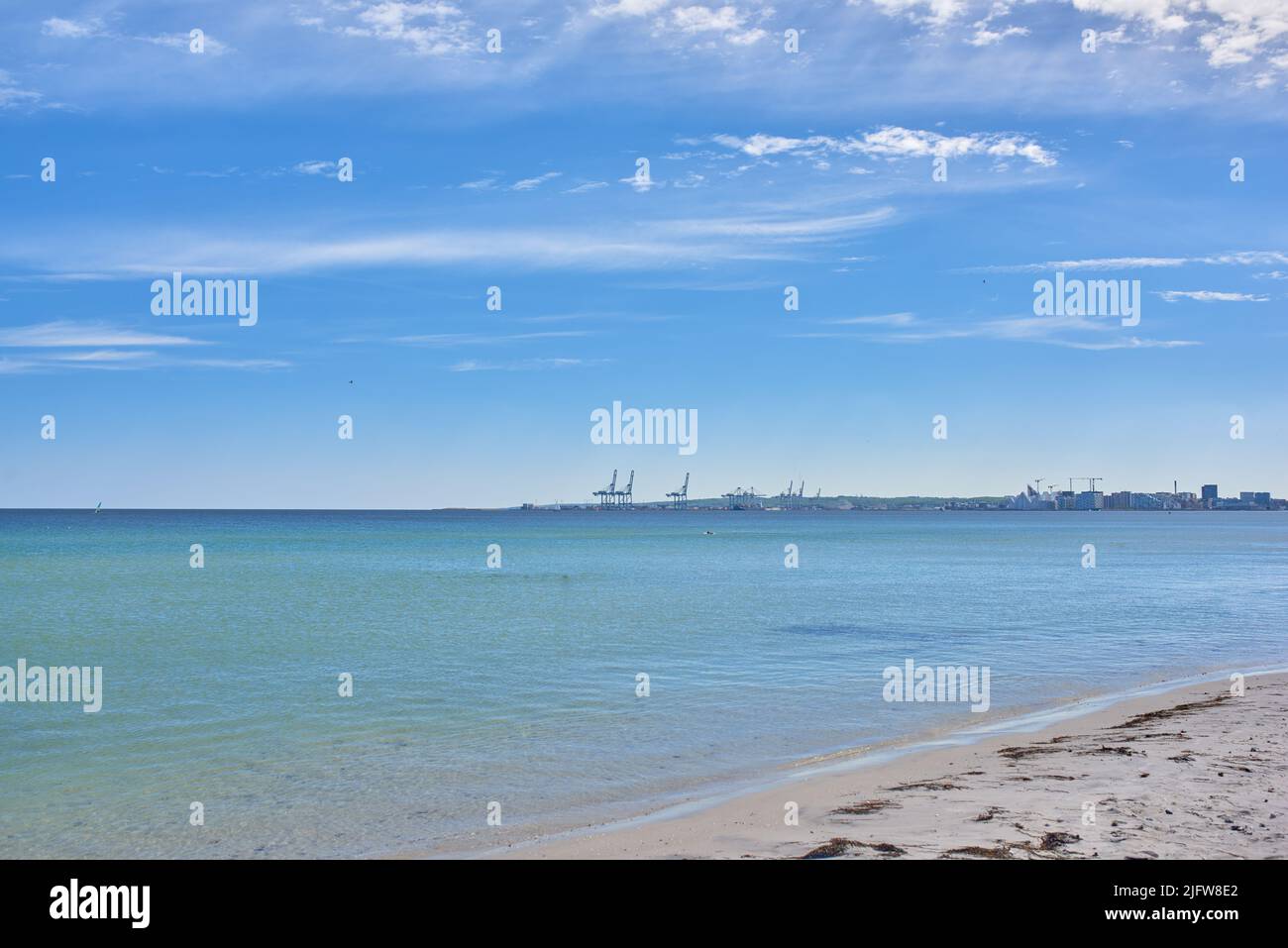 Copy space at the sea with a blue sky background. Calm ocean waves wash ...
