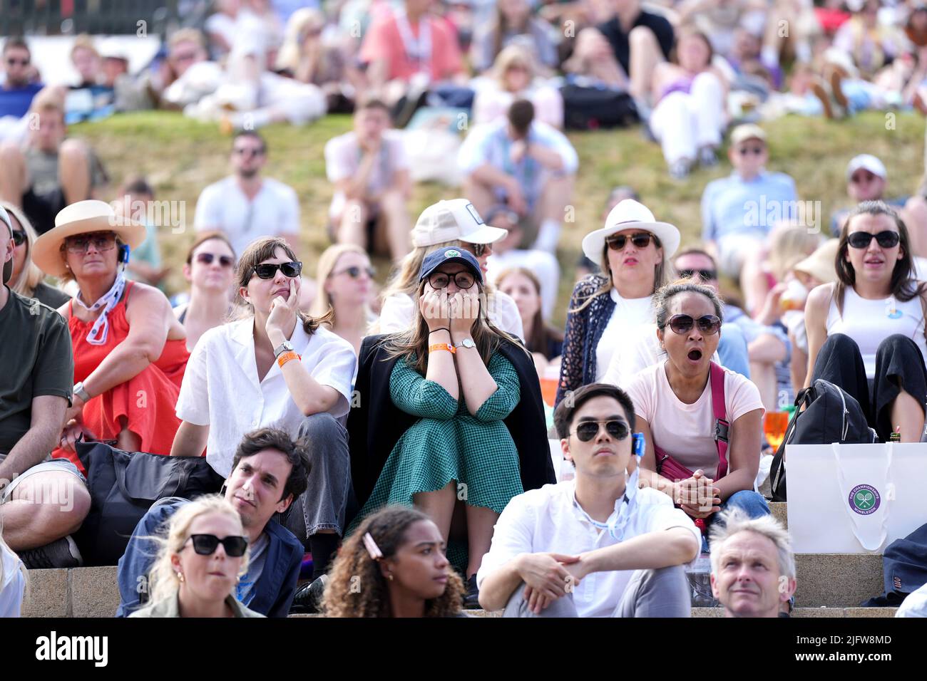 Spectators watch the action on the big screens on the hill outside ...