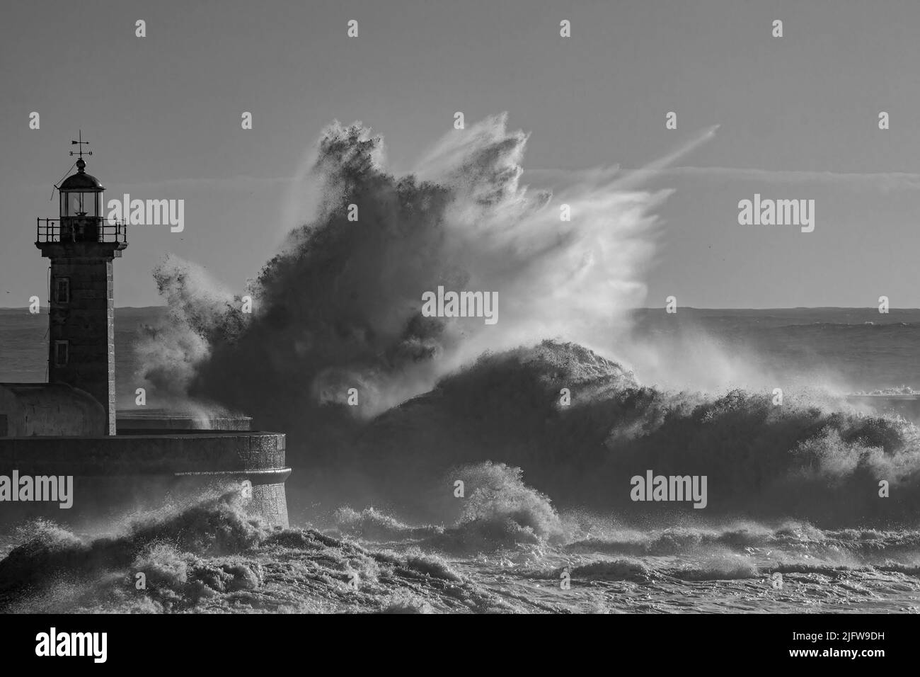 Big wave splash. Douro river mouth old pier and lighthouse. Used ...