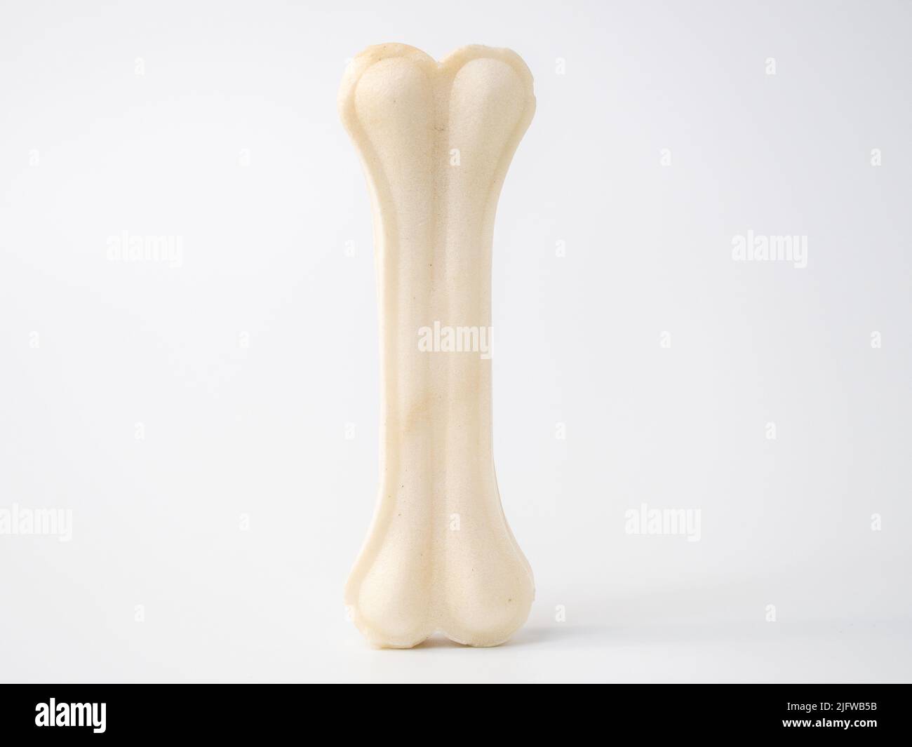 Pressed rawhide bone shaped dog chews isolated on a white background ...