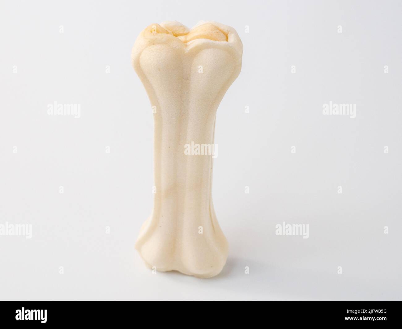 Pressed rawhide bone shaped dog chews isolated on a white background ...
