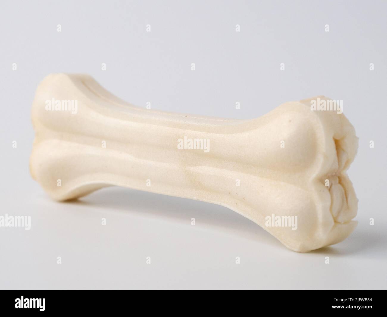 Pressed rawhide bone shaped dog chews isolated on a white background ...