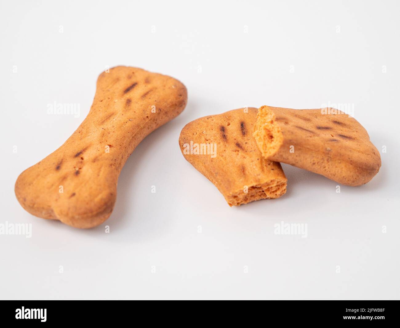 Dog biscuits in the shape of a bone on a white background Stock Photo ...