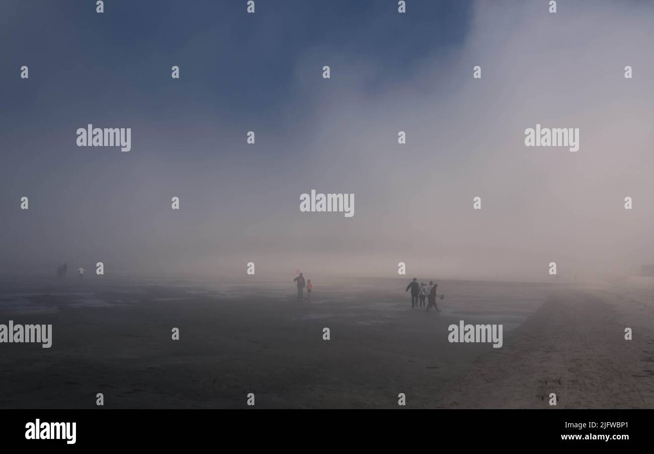 People walking on the misty beach hi-res stock photography and images ...