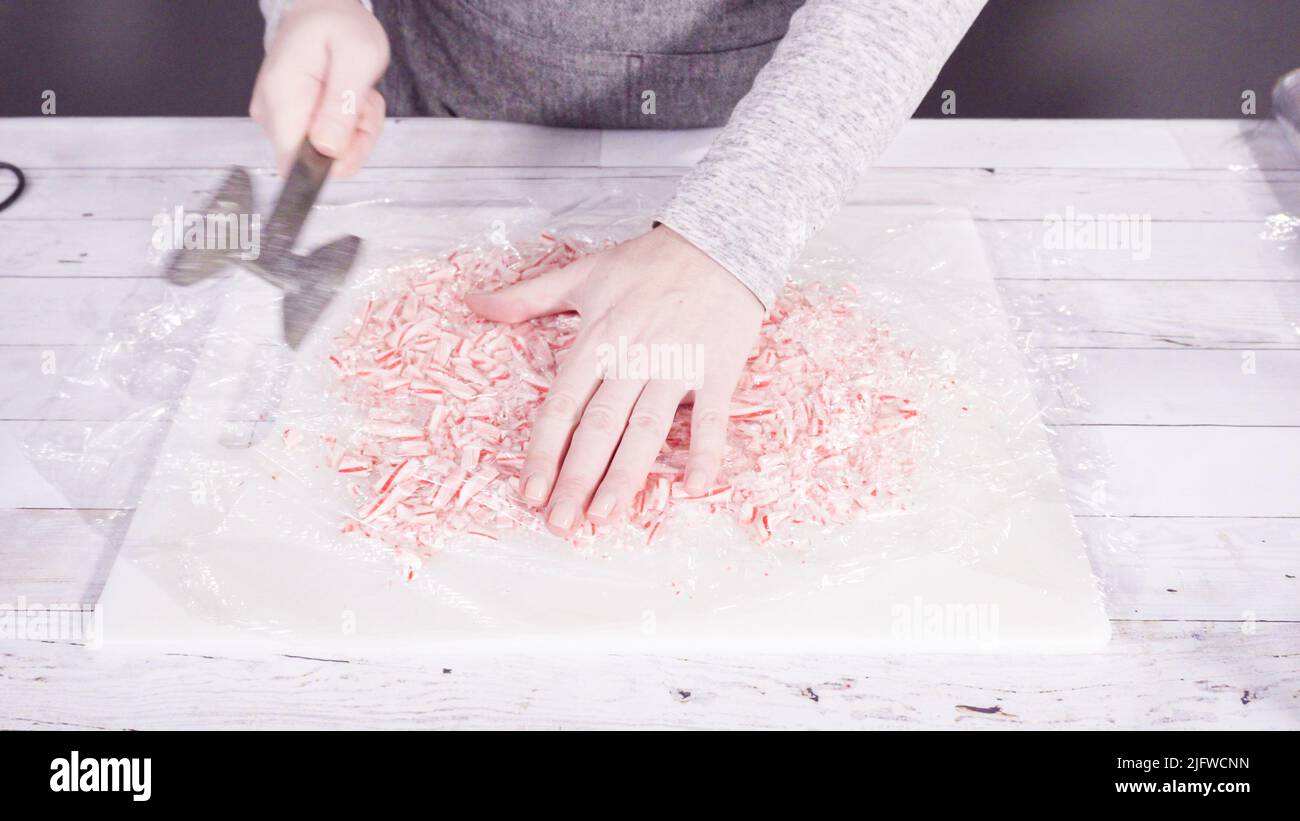 Step by step. Breaking candy cane candies into small pieces Stock Photo ...