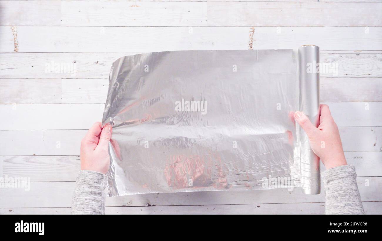 Flat lay. Step by step. Lining the baking pan with cooking foil to make ...