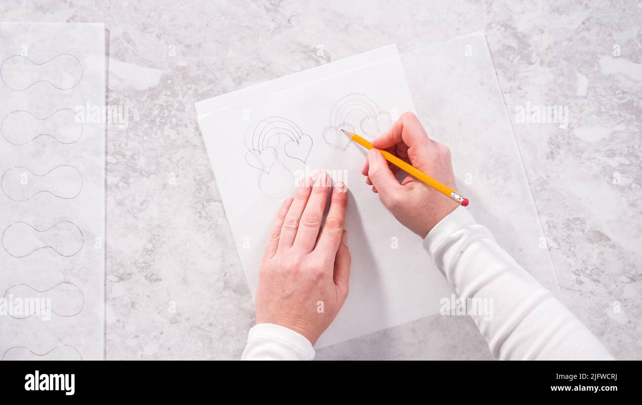 Flat lay. Step by step. Drawing outlines with pencil on parchment paper ...