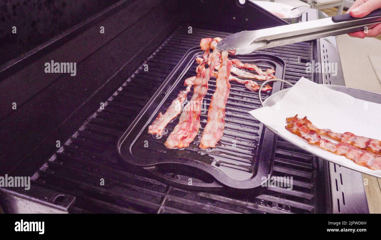 Cooking bacon stips on an outdoor gas grill Stock Photo - Alamy