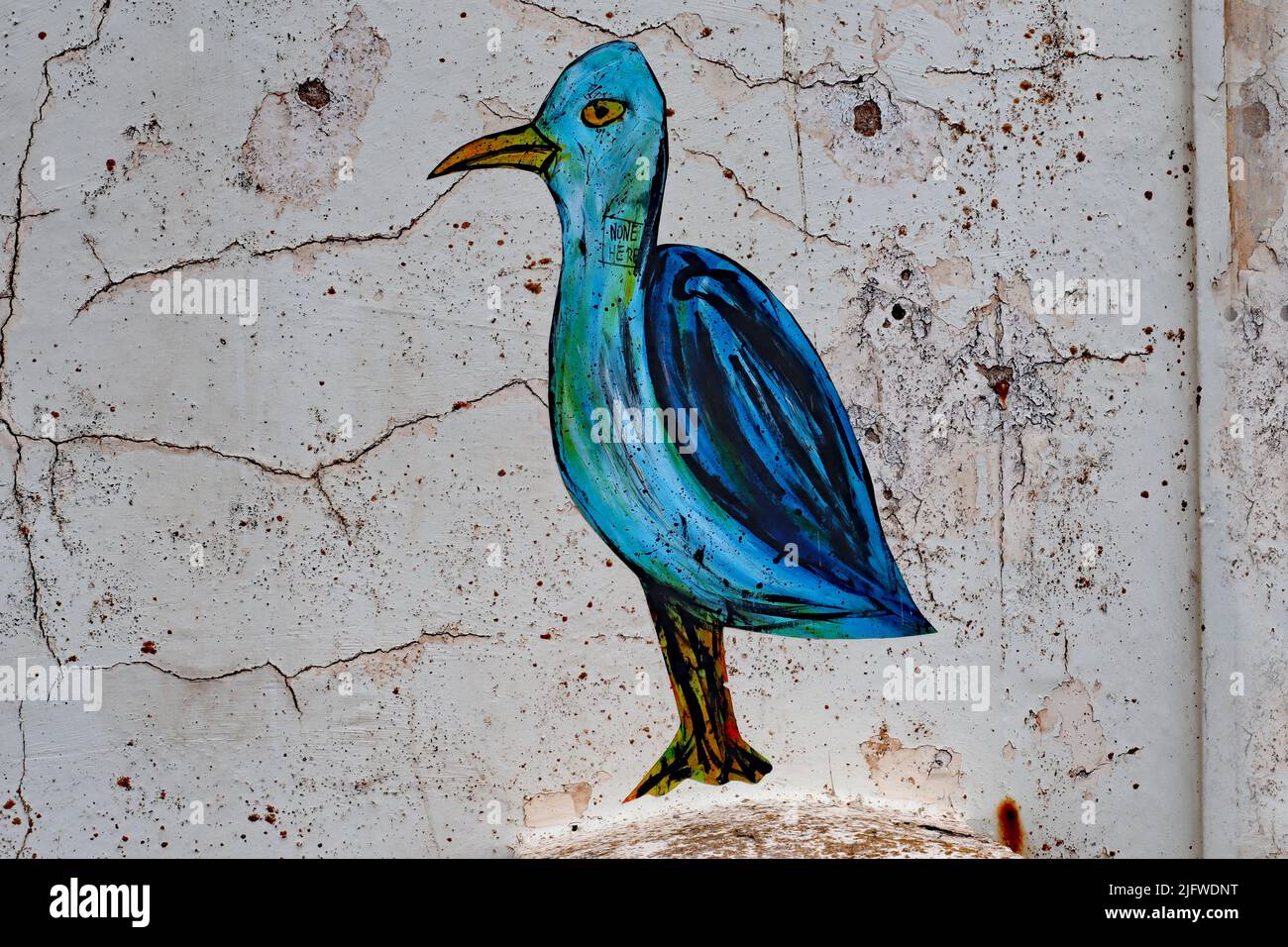 A two tone graffiti bird painted on the wall of a derelict building on ...