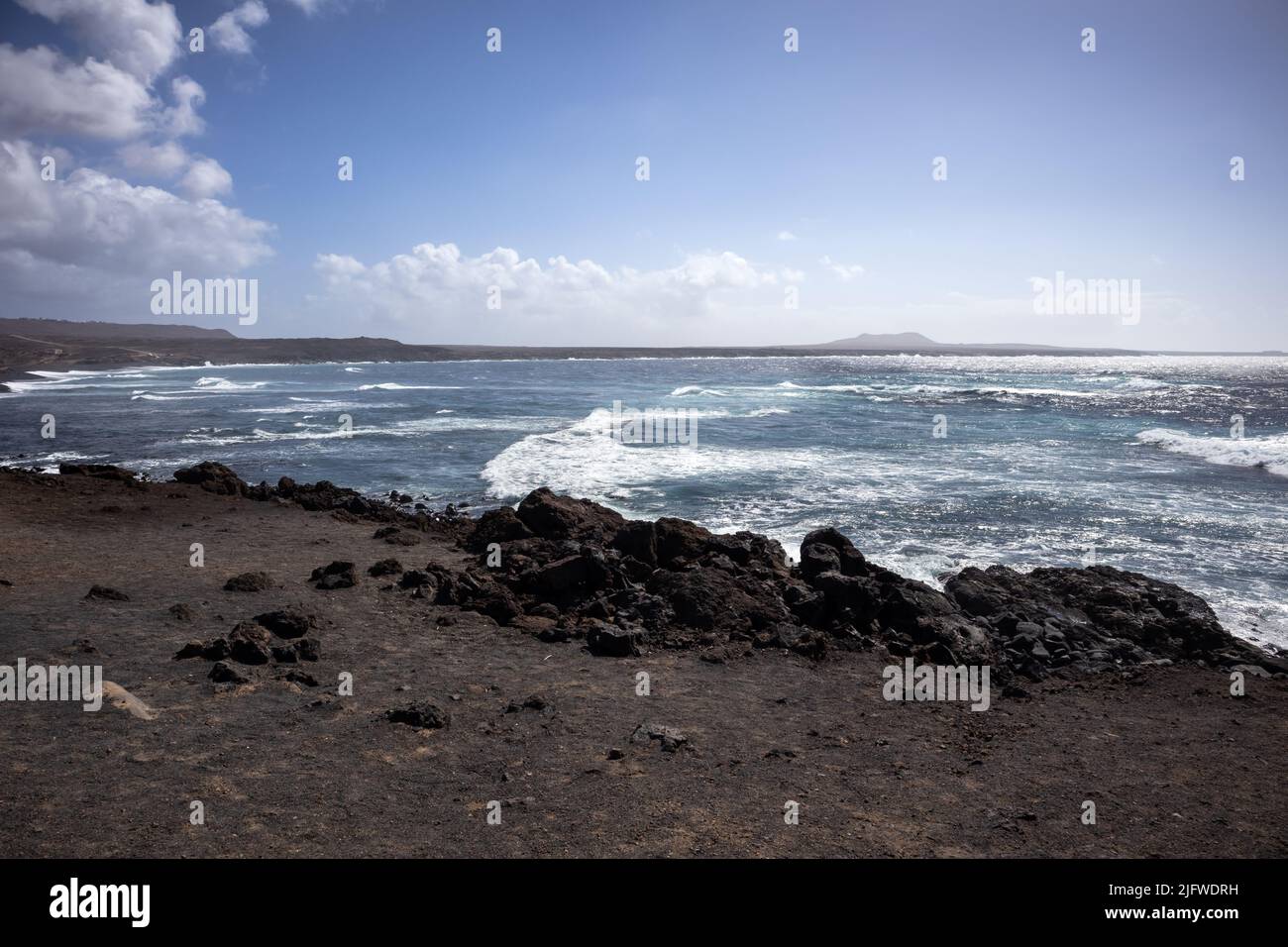 Rocks made of dark brown to black lava, creating the Atlantic ocean ...