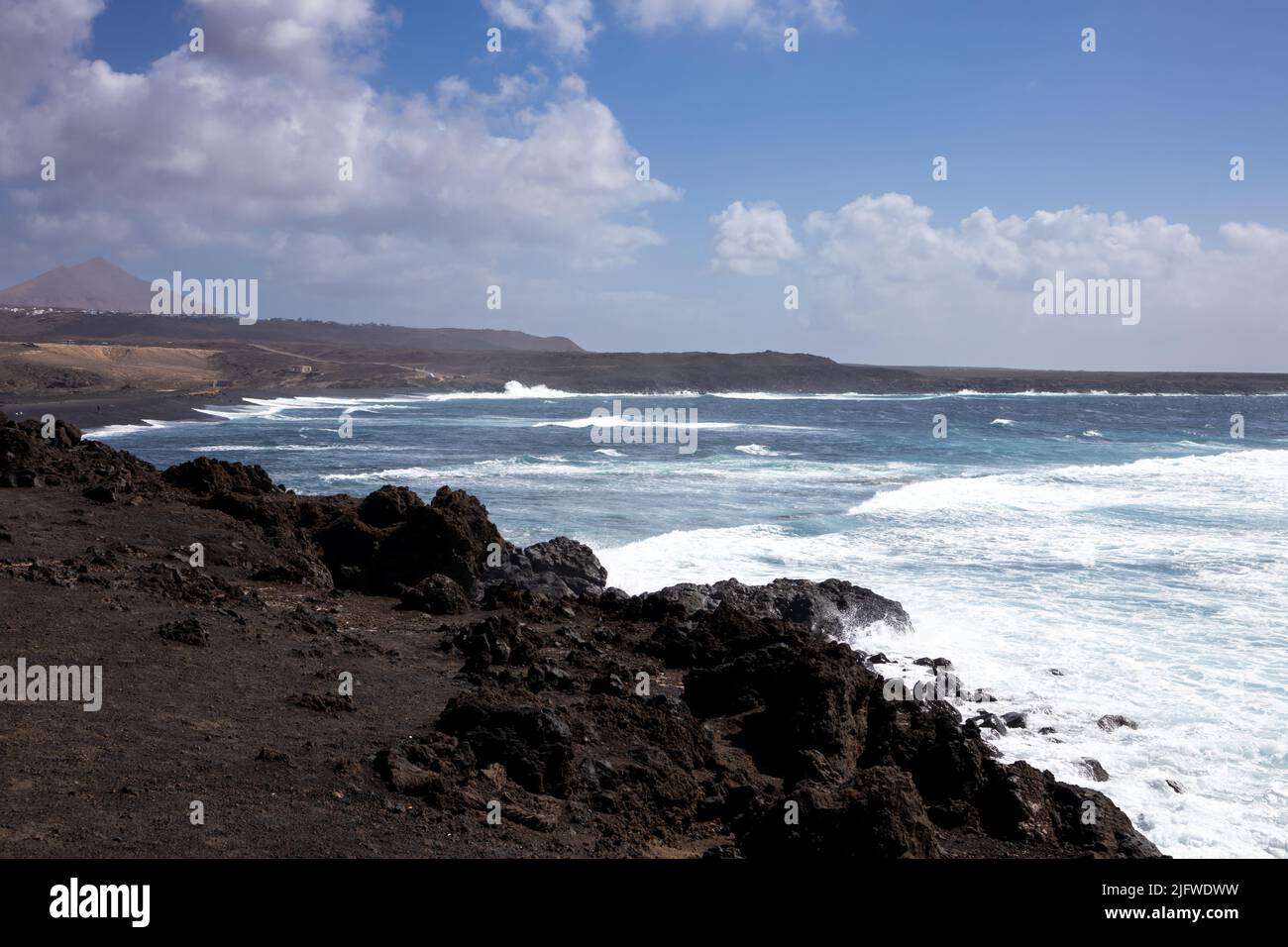 Rocks made of dark brown to black lava, creating the Atlantic ocean ...