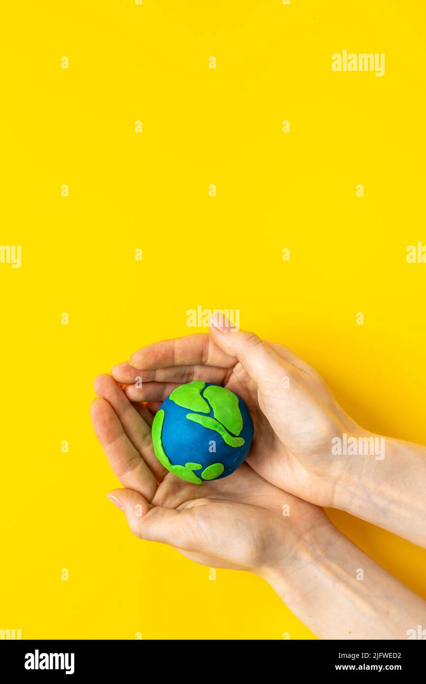 Modeling clay world in hands. Earth Day concept Stock Photo - Alamy
